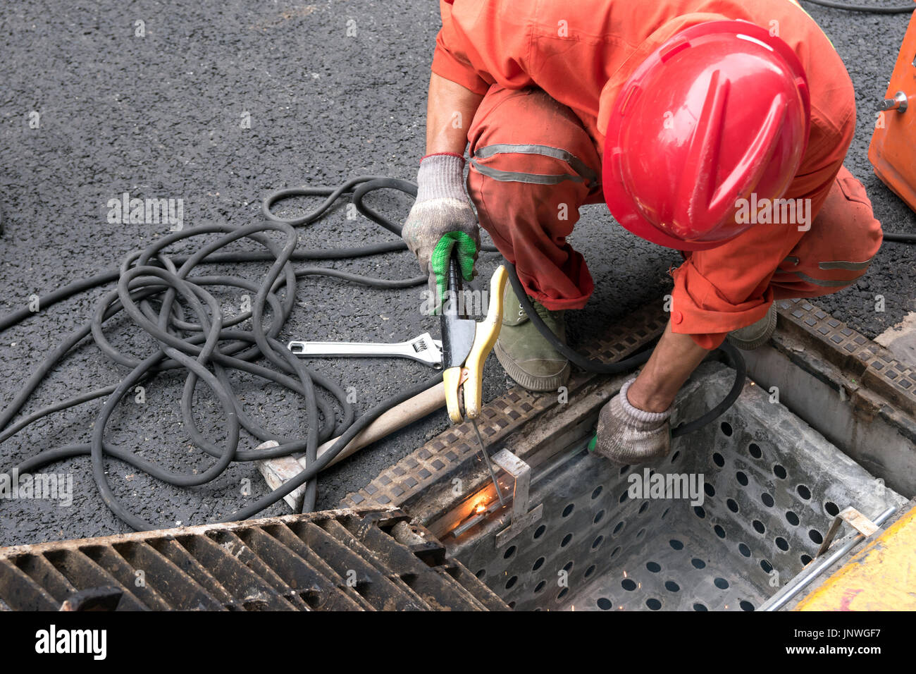 Worker use iron oxide electrode to steel metal welding waste filter ...