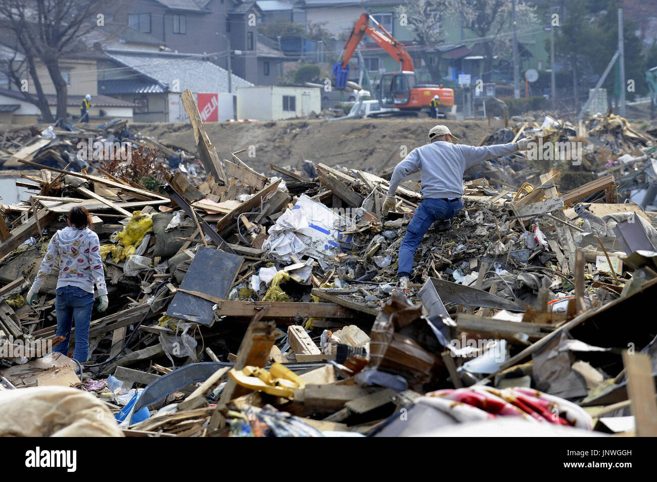 OFUNATO, Japan - A man and his daughter look through the rubble of ...