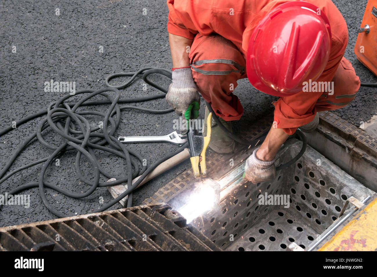 Worker use iron oxide electrode to steel metal welding waste filter ...