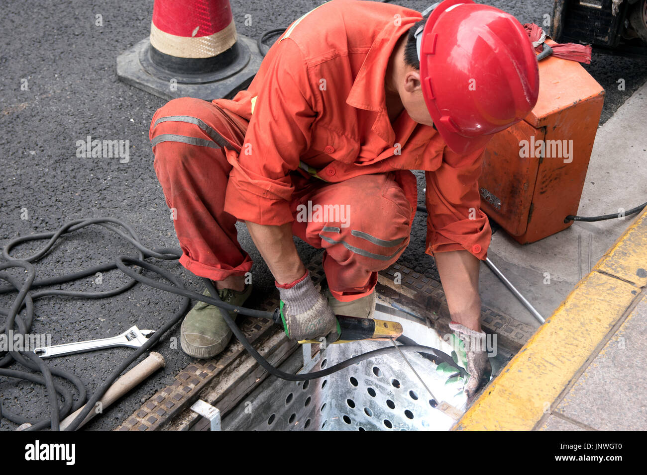 Worker use iron oxide electrode to steel metal welding waste filter ...