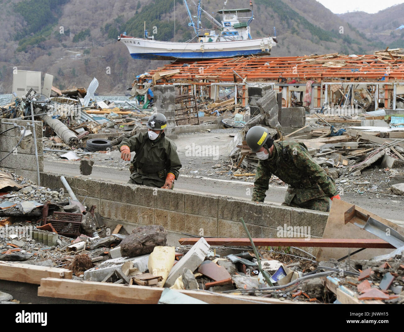 ONAGAWA, Japan - Members of the Self-Defense Forces clean up debris in ...