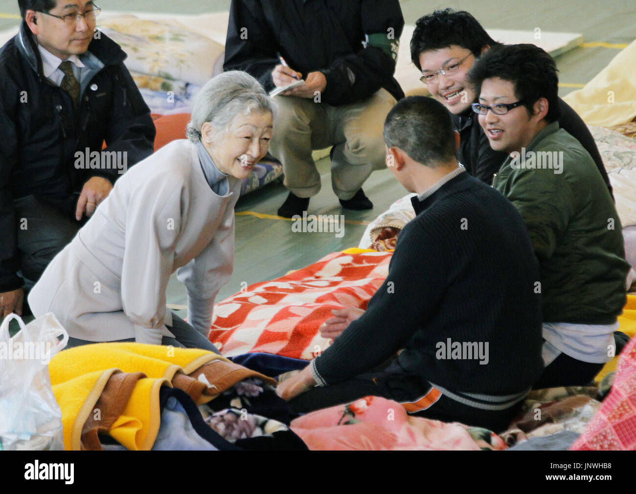 MINAMISANRIKU, Japan - Empress Michiko (L front) encourages people ...