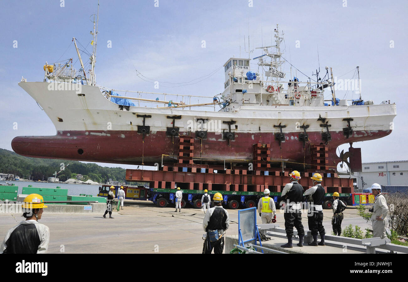 KESENNUMA, Japan - A fishing boat washed ashore by the March 11 tsunami ...