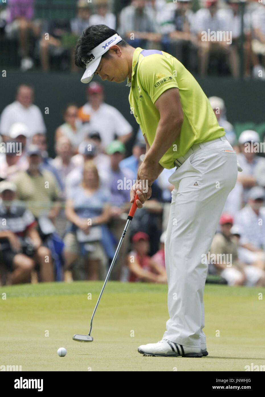 BETHESDA, United States - Y.E. Yang of South Korea putts for a birdie ...