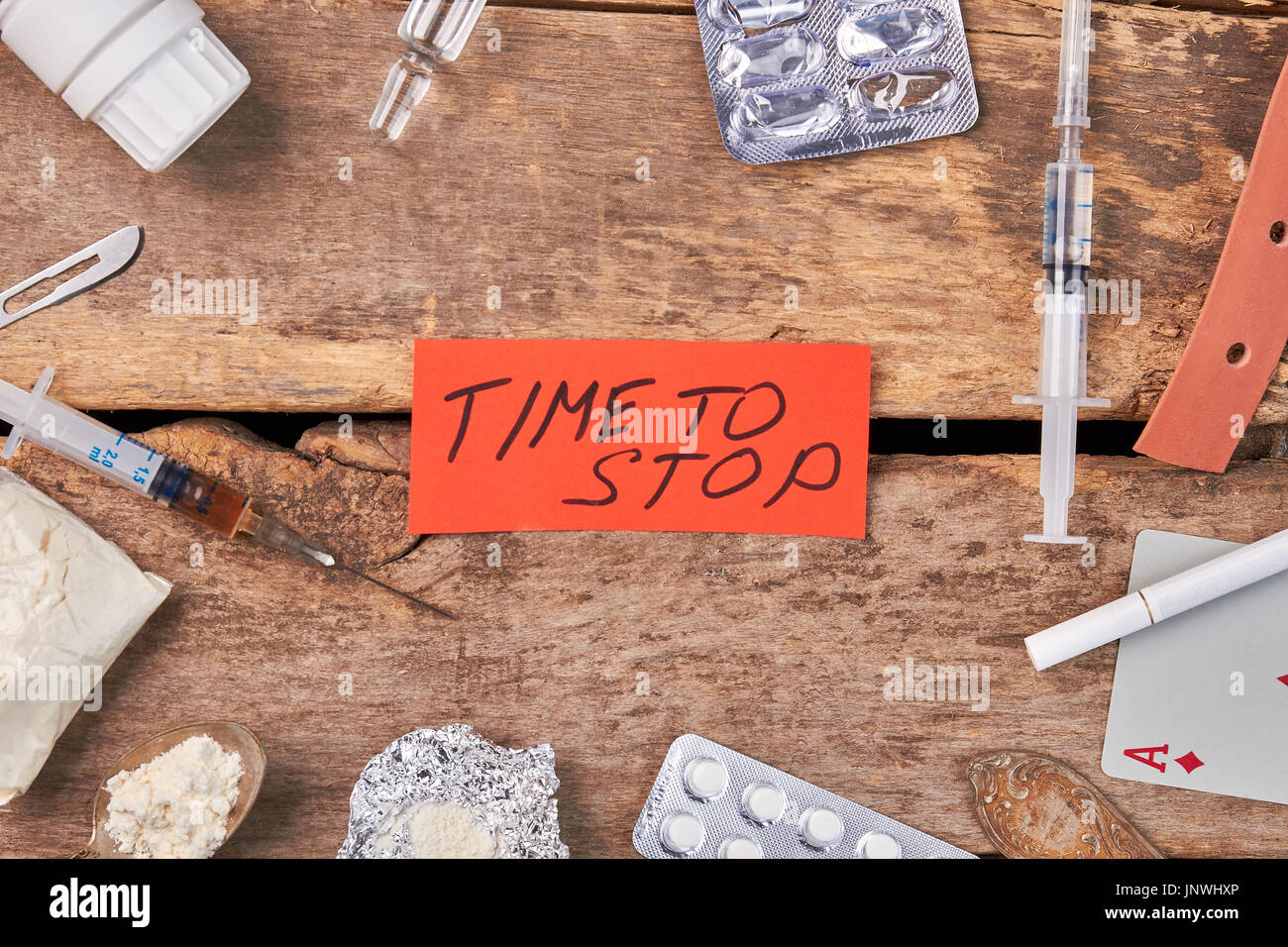 Narcotics, message, old wooden background Stock Photo - Alamy
