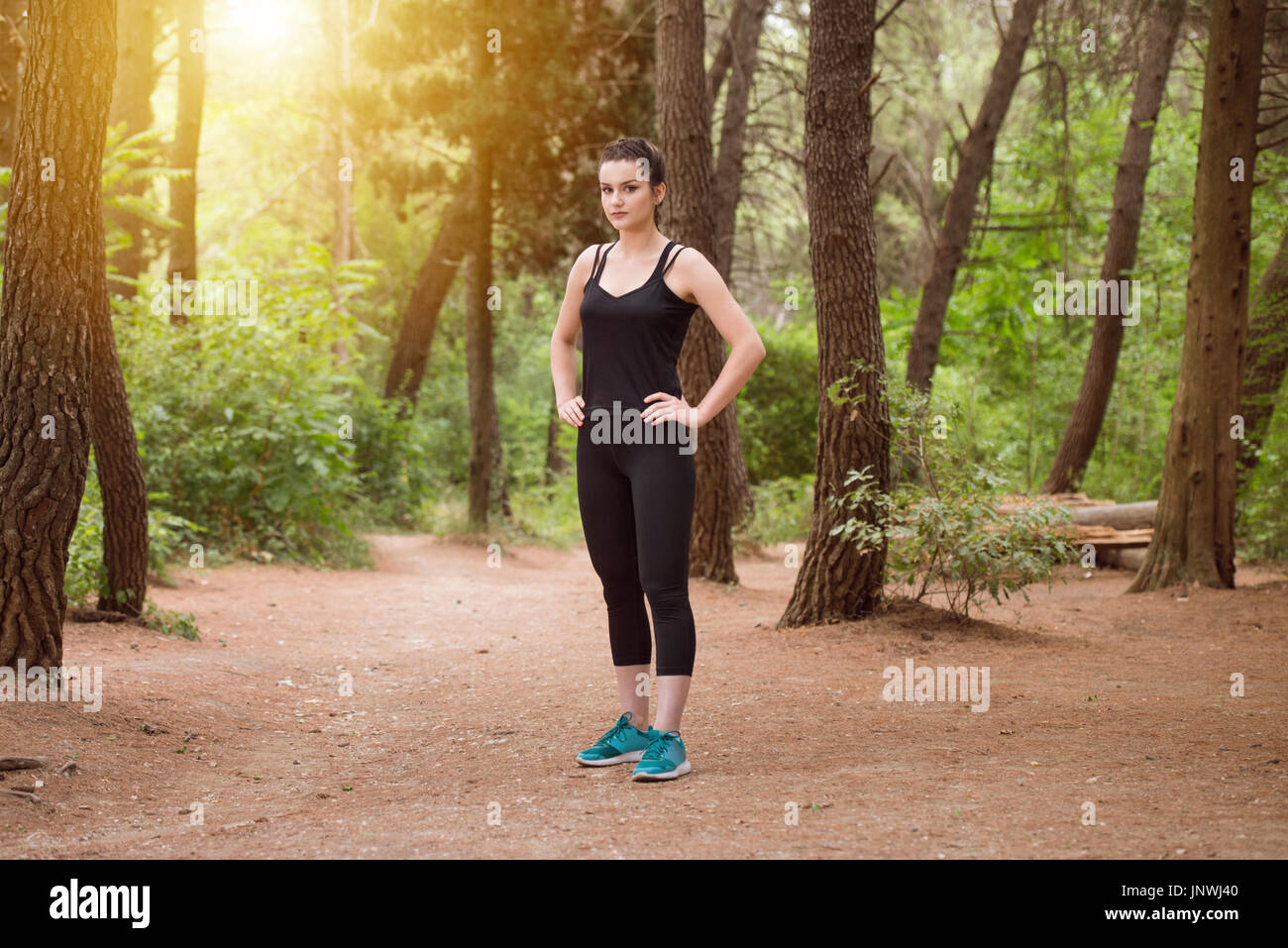 Portrait of a Young Woman Running In Wooded Forest Area - Training And ...