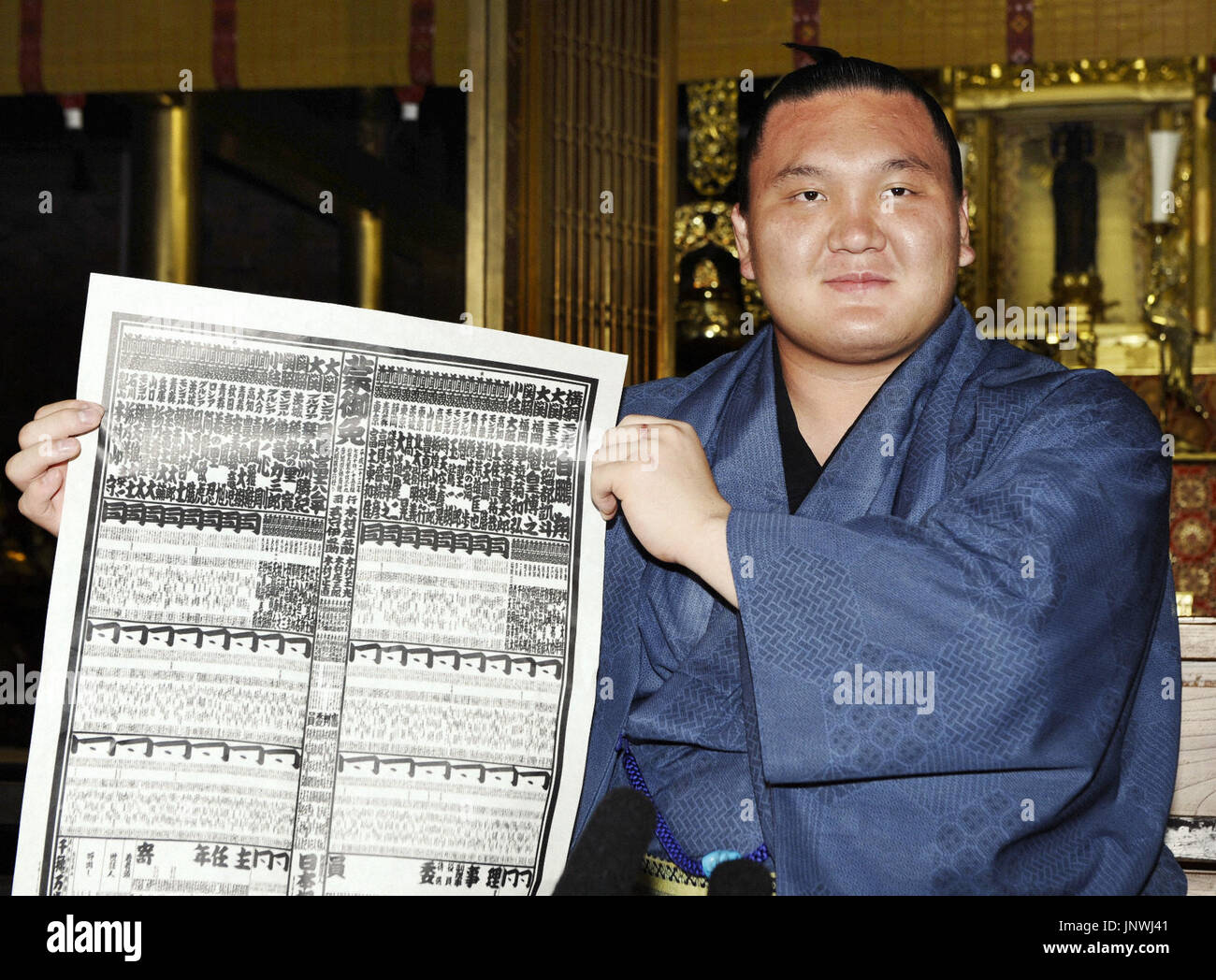 NAGOYA, Japan - Grand champion Hakuho from Mongolia shows the banzuke ...