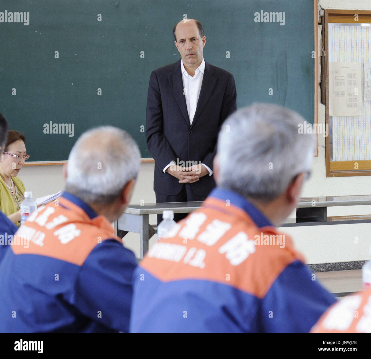 OFUNATO, Japan - U.S. Ambassador to Japan John Roos listens to Japanese ...