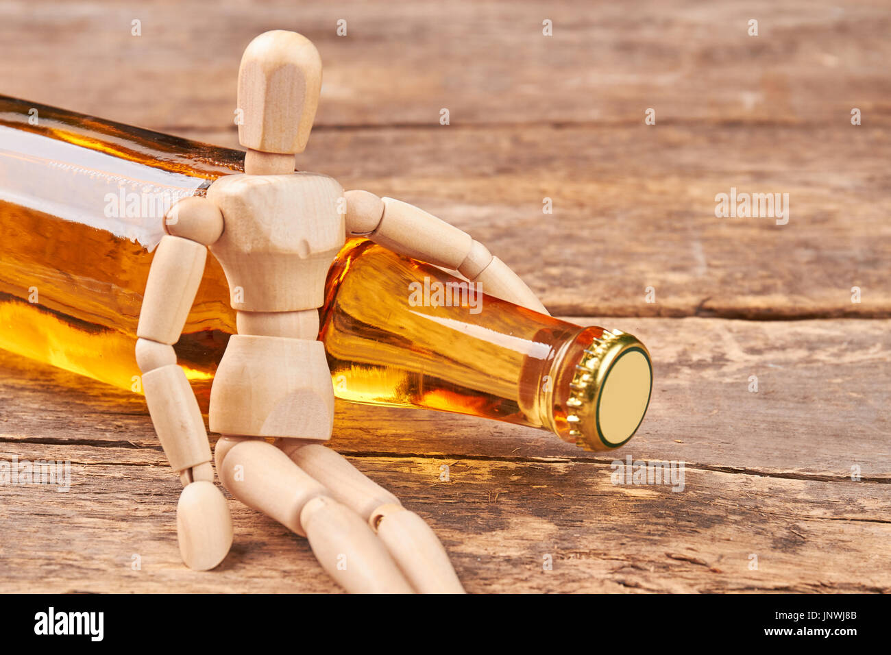 Human wooden dummy hugs bottle Stock Photo - Alamy