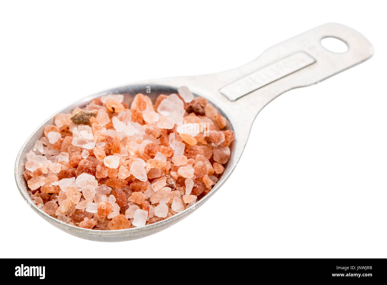 isolated measuring tablespoon of Himalayan salt - pink and orange ...