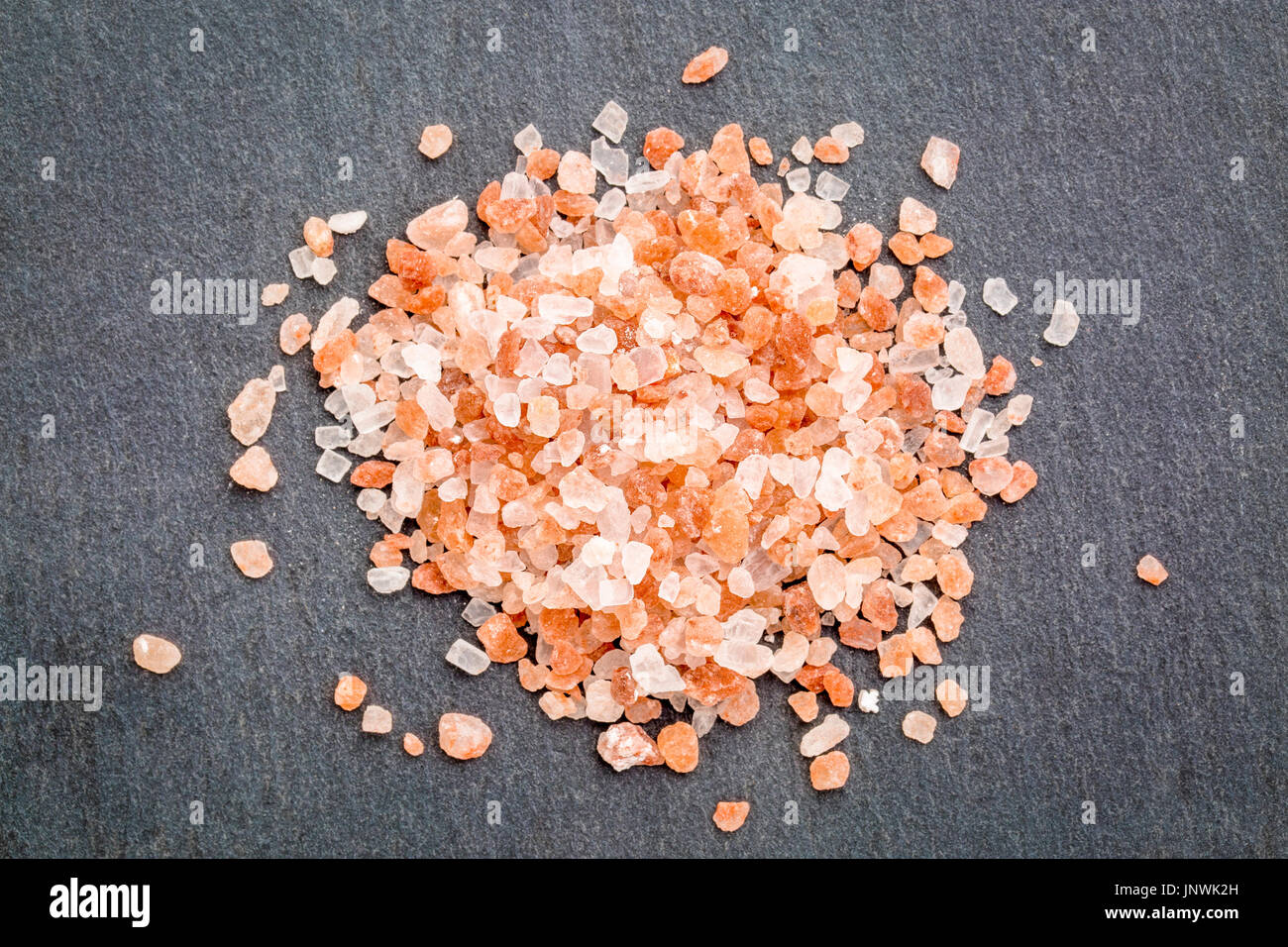 background of Himalayan salt - a heap of pink and orange coarse ...