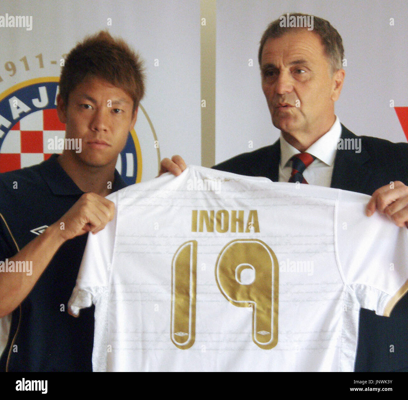 BAD KLEINKIRCHHEIM, Austria - Japan defender Masahiko Inoha (L) shows his new jersey at a press ...