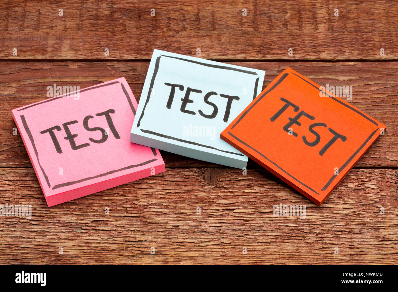 test concept - handwriting in black ink on colorful sticky notes ...
