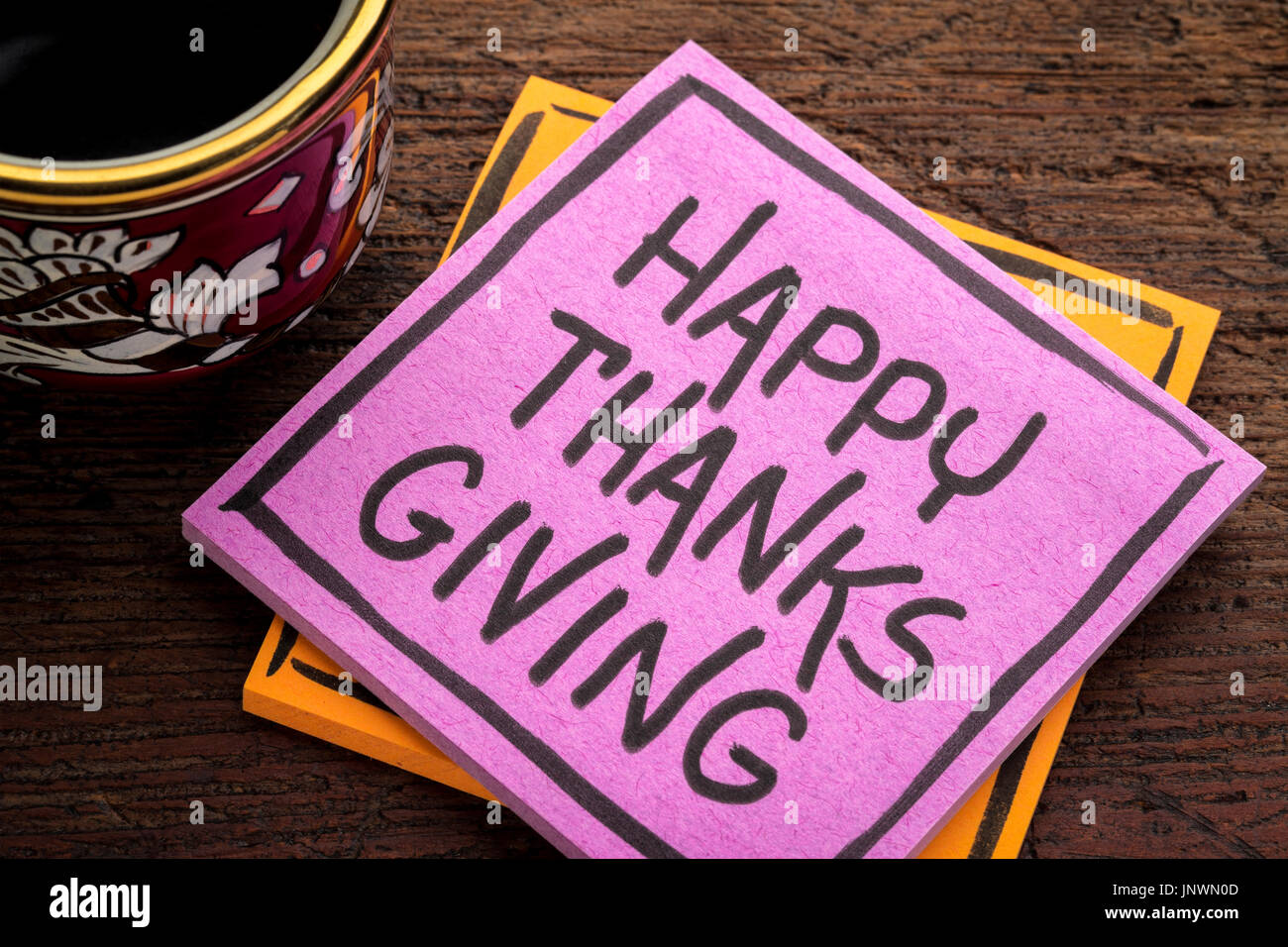 Happy Thanksgiving - handwriting in black ink on a sticky note with a ...