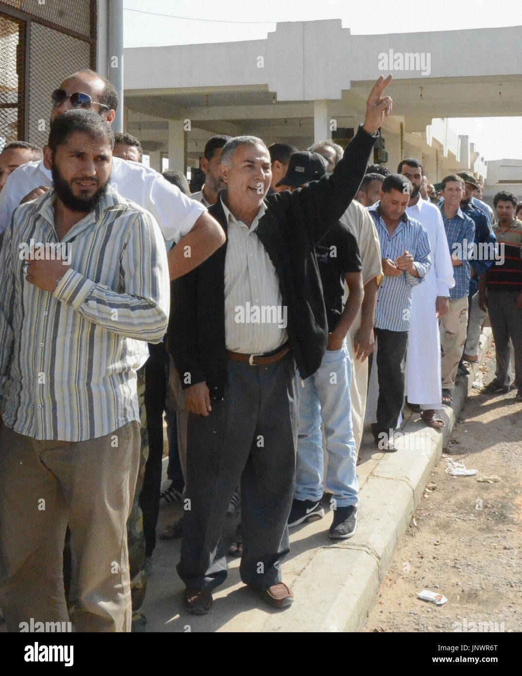 MISRATA, Libya - People stand in line to see the body of former Libyan ...