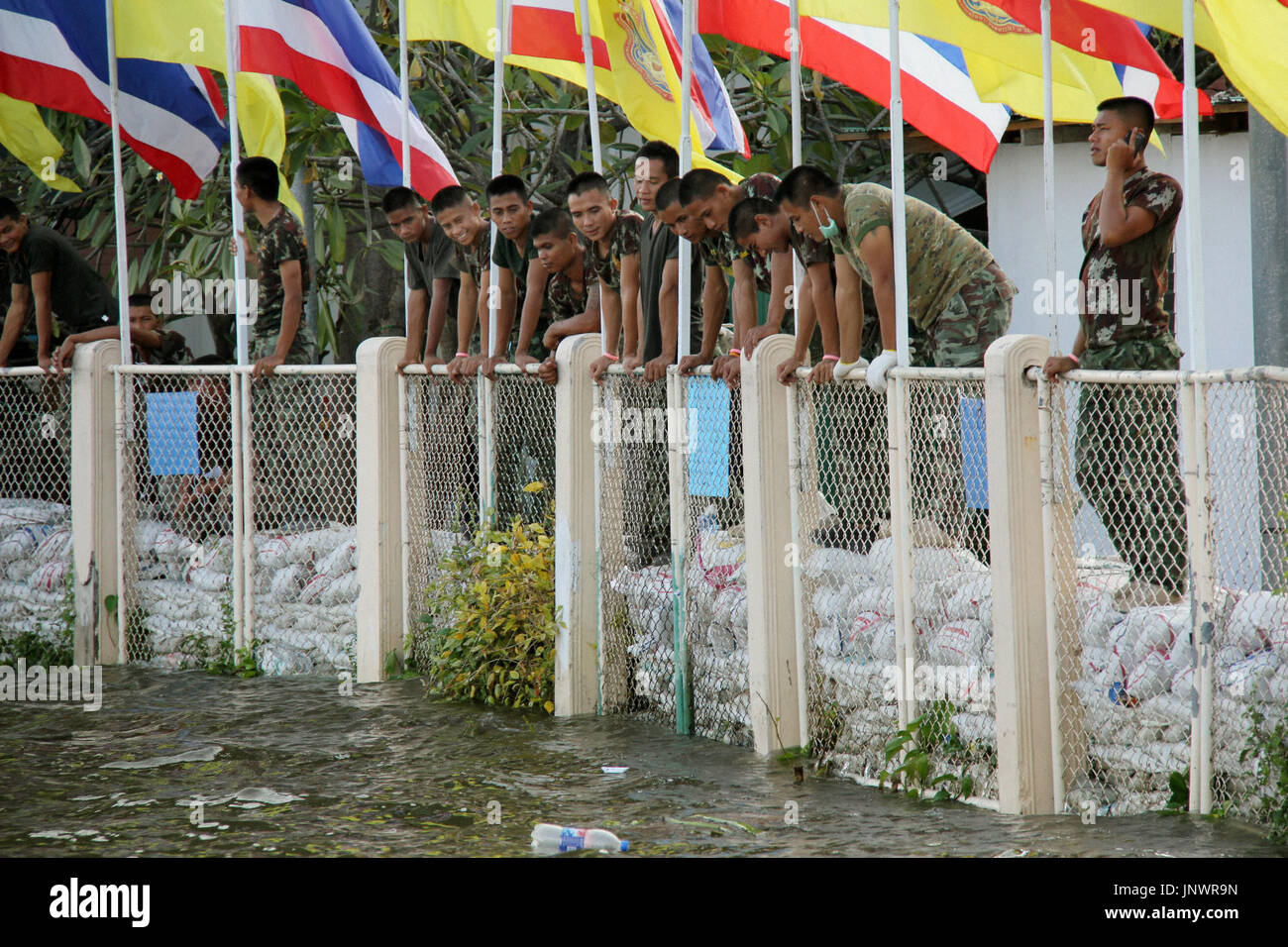 BANGKOK, Thailand - Thai soldiers watch the water level of the Chao ...