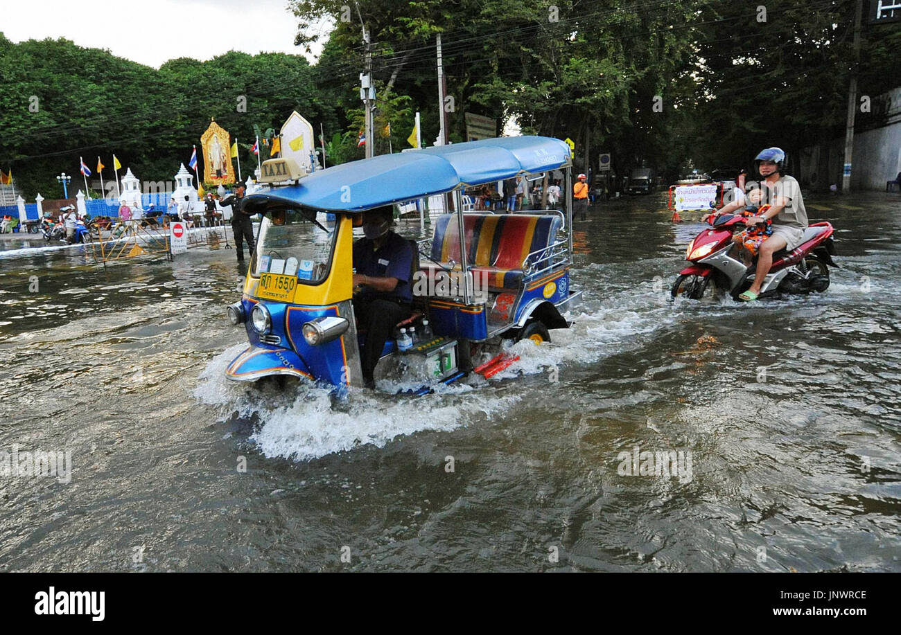 BANGKOK, Thailand - A three-wheel auto rickshaw called a tuk-tuk drives ...