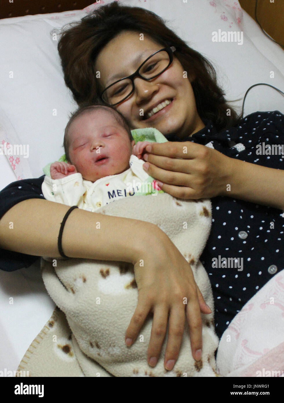 FUKUSHIMA, Japan - Tomoko Watanabe, 20, holds her son, who was born on ...