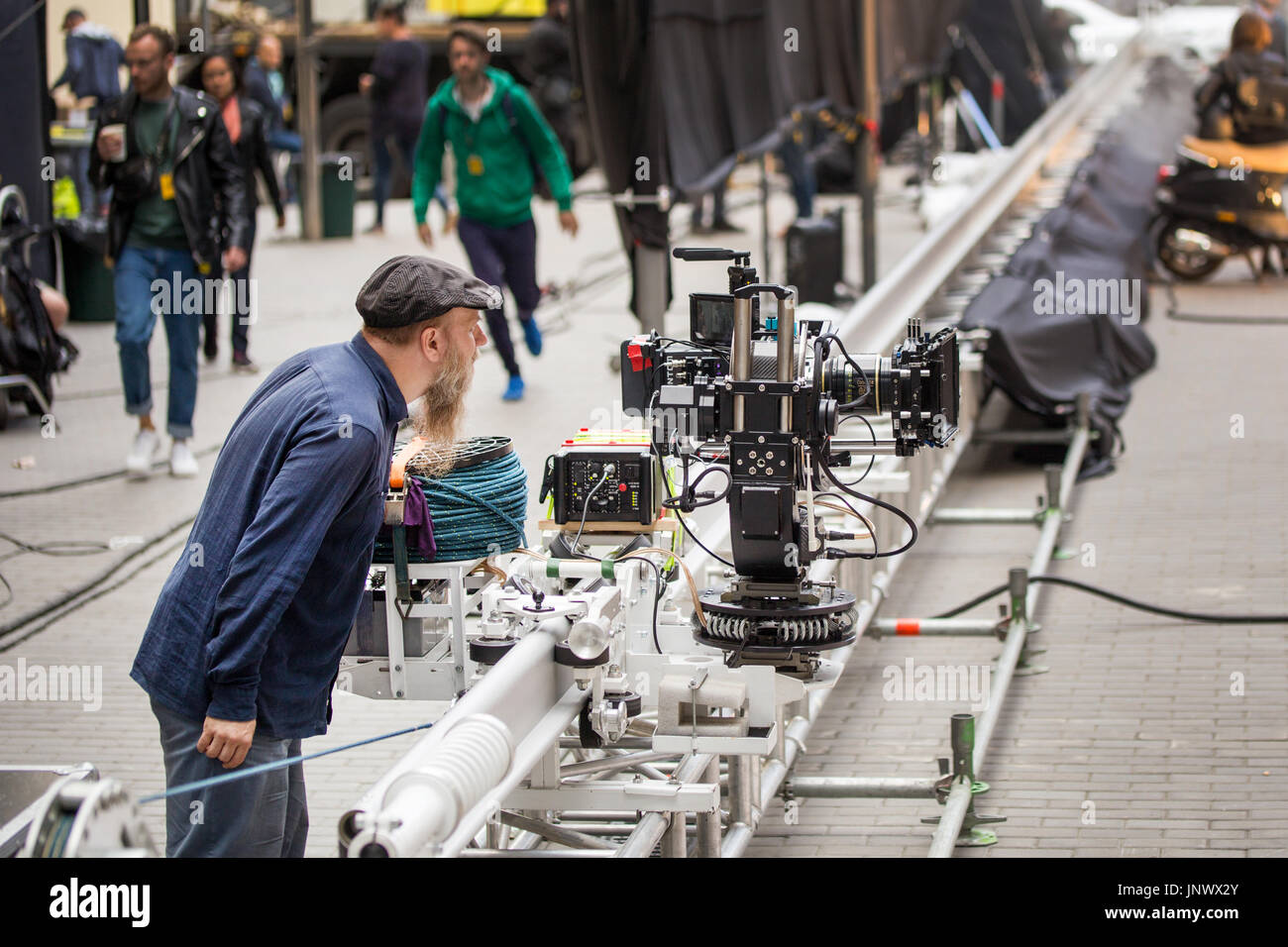 A cameraman looking to the display of big professional video camera ...