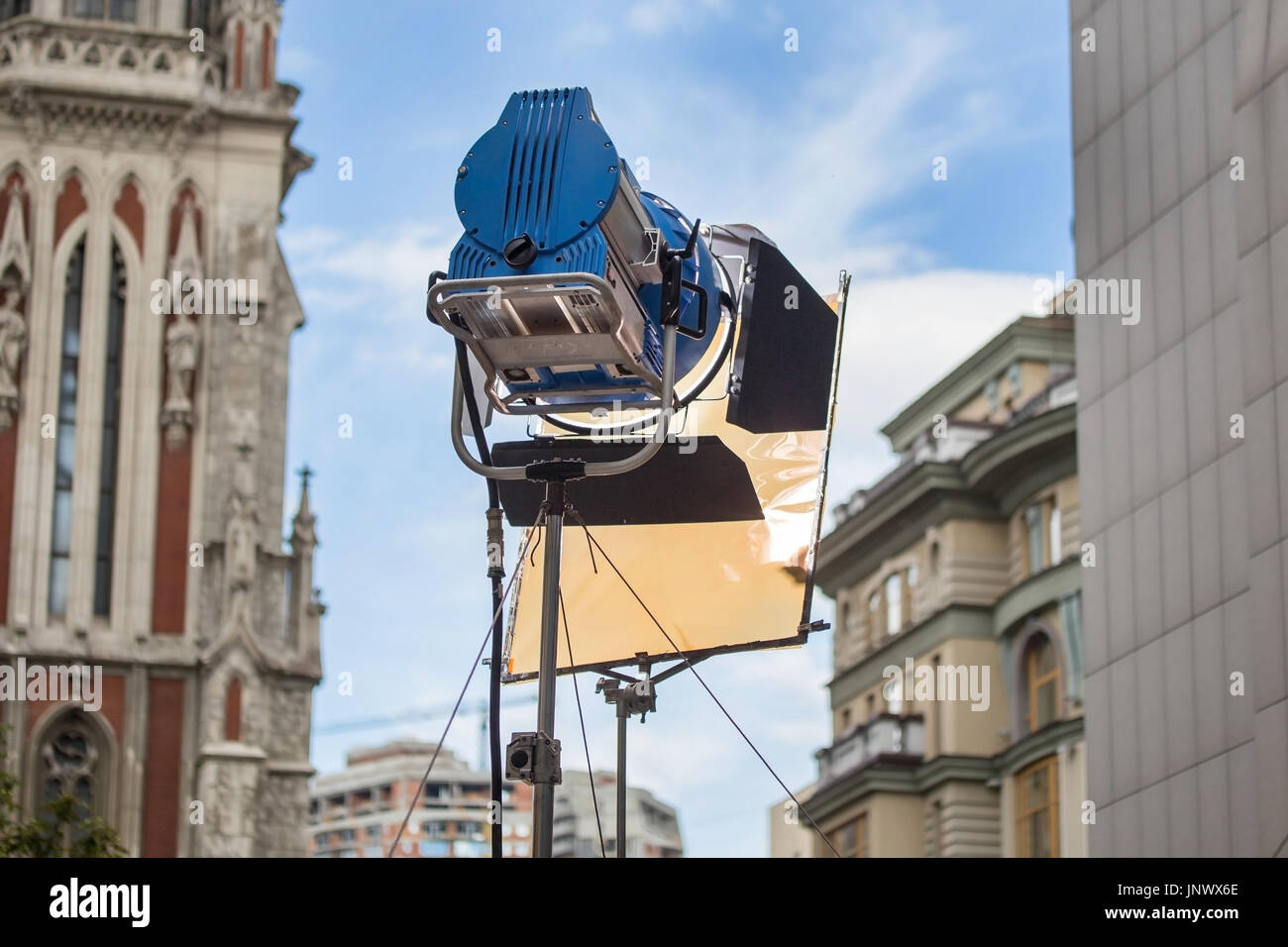 Big professional bright spotlight with color filter on a tripod ...