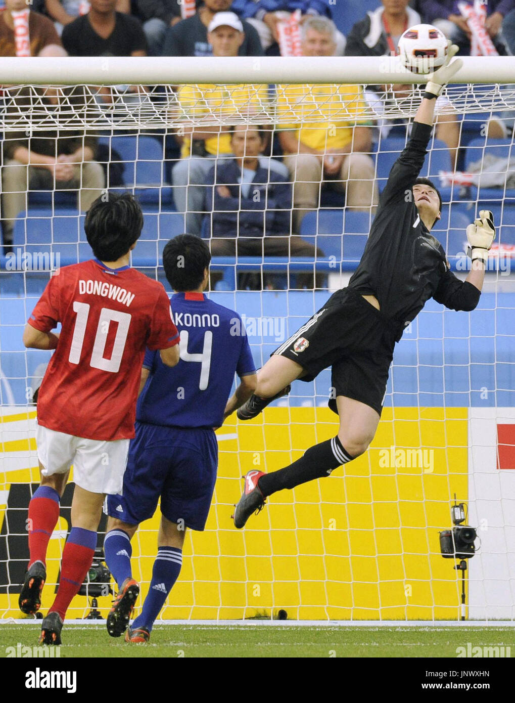 DOHA, Qatar - Japanese goal keeper Eiji Kawashima (R) pulls off a save ...