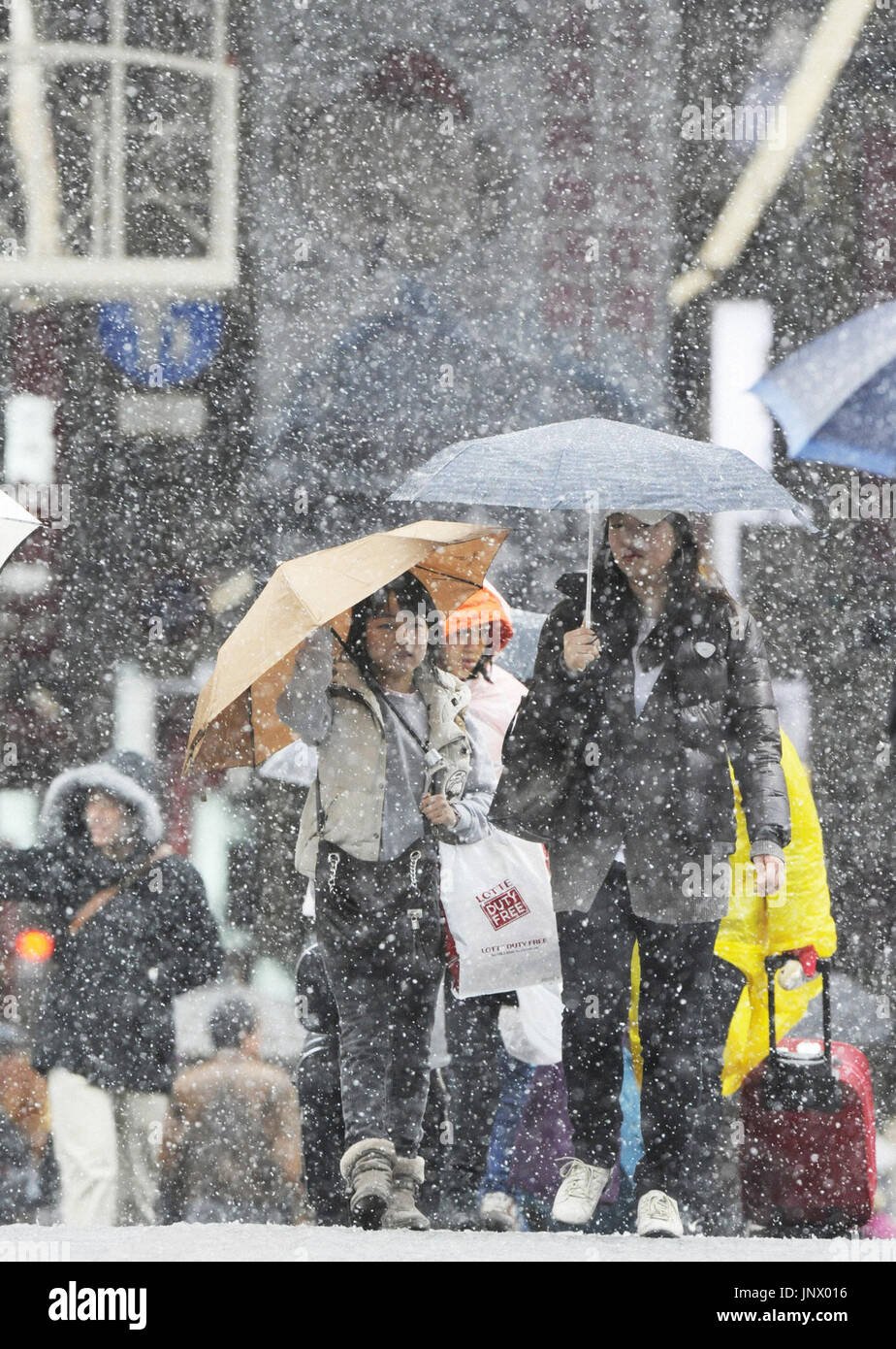 OSAKA, Japan - People walk in the snow on a street in Osaka on Feb. 11 ...