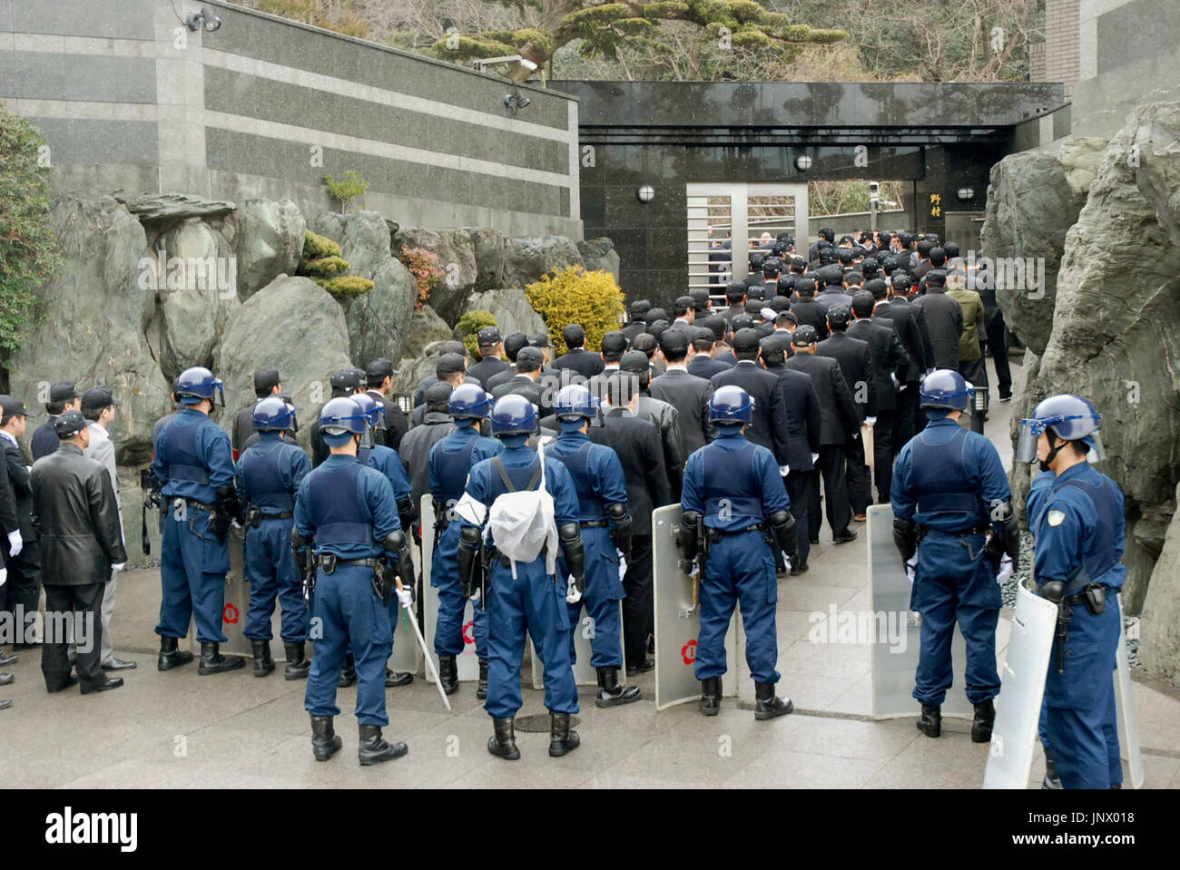 KITAKYUSHU, Japan - Police officers line up in front of the home of the ...