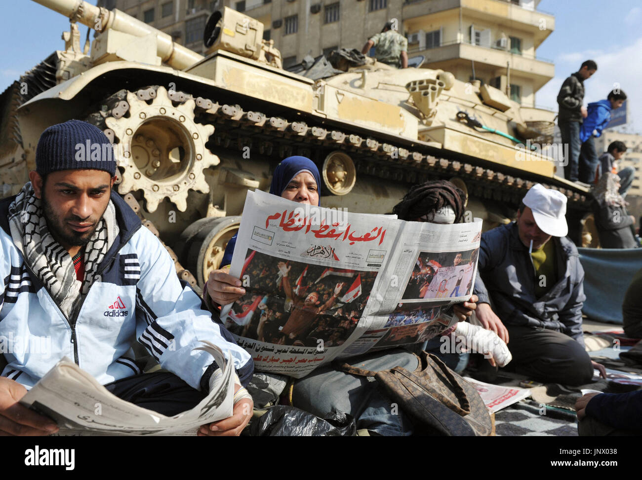 CAIRO, Egypt - People read newspapers at Tahrir Square in Cairo on Feb ...