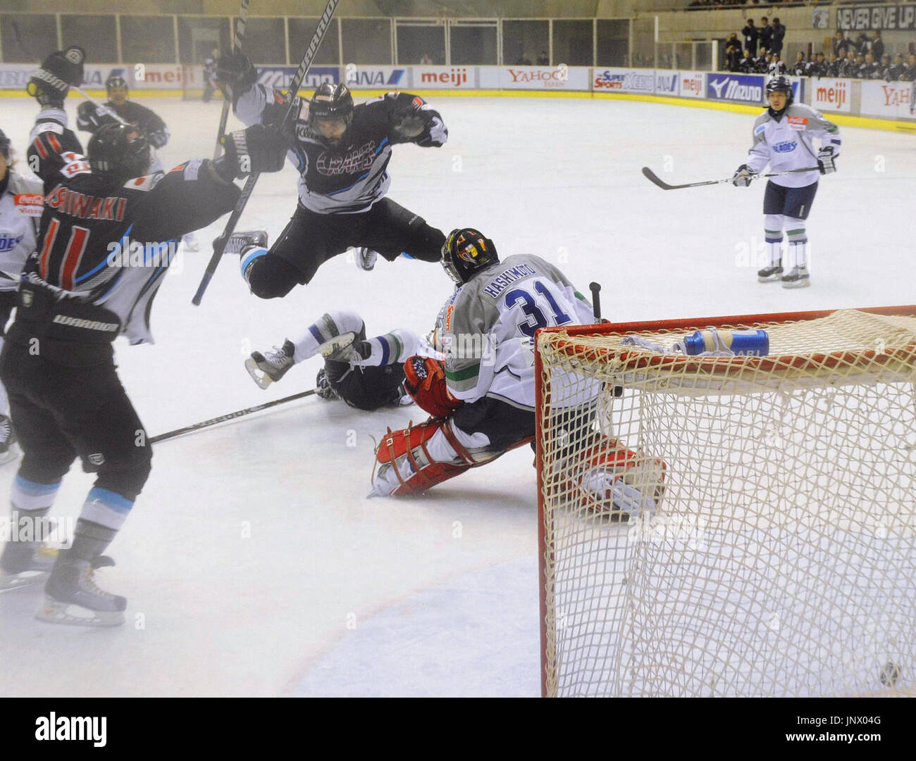TOCHIGI, Japan - The Nippon Paper Cranes' Mike Madill (C) leaps after ...