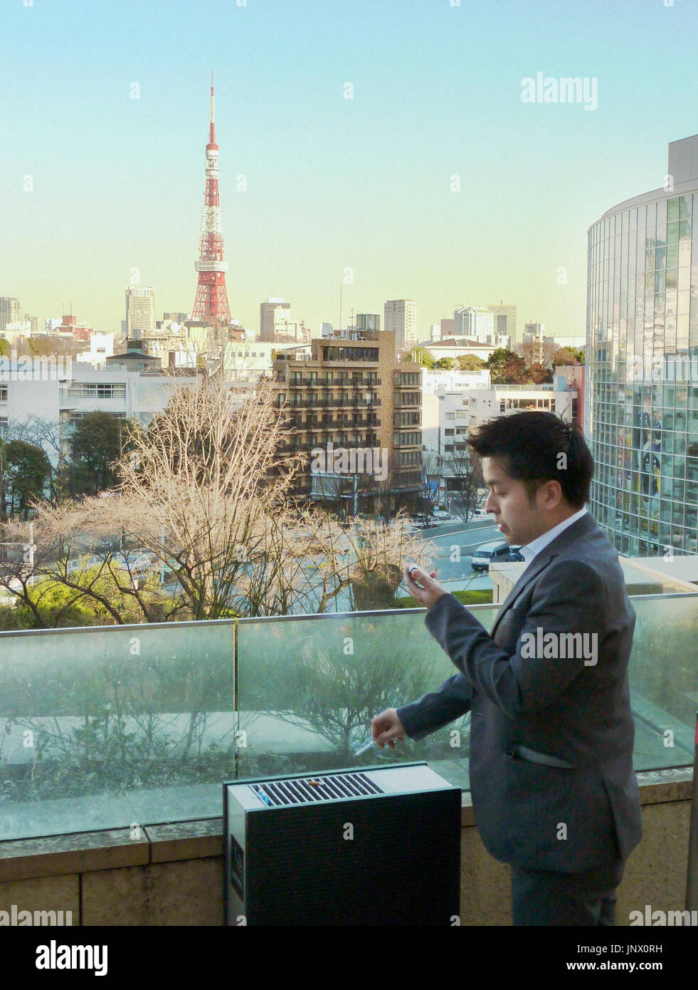 TOKYO, Japan - A smoker takes a break at a smoking area in the Roppongi ...