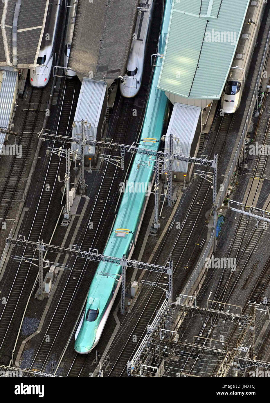 TOKYO, Japan - The new Hayabusa bullet train (green train, 2nd from R ...