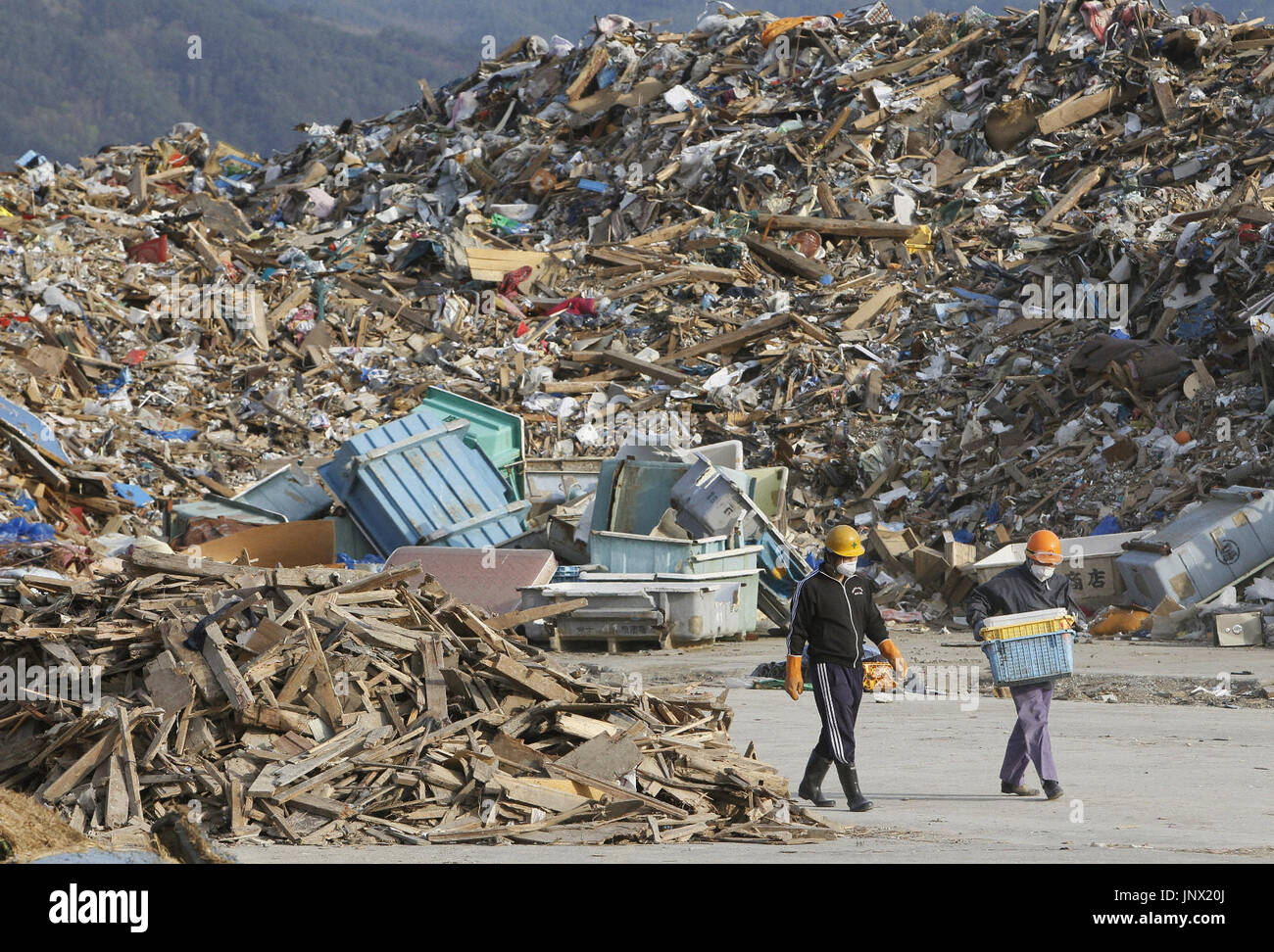 MIYAKO, Japan - People walk around a heap of debris near Miyako port in ...