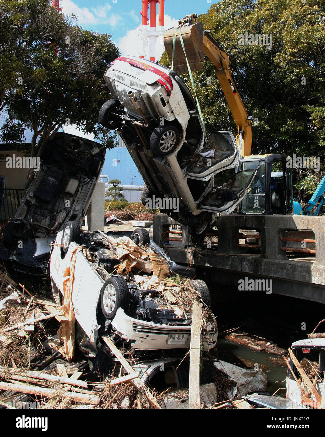 SENDAI, Japan - An auto hit by the March 11 tsunami is lifted by an ...