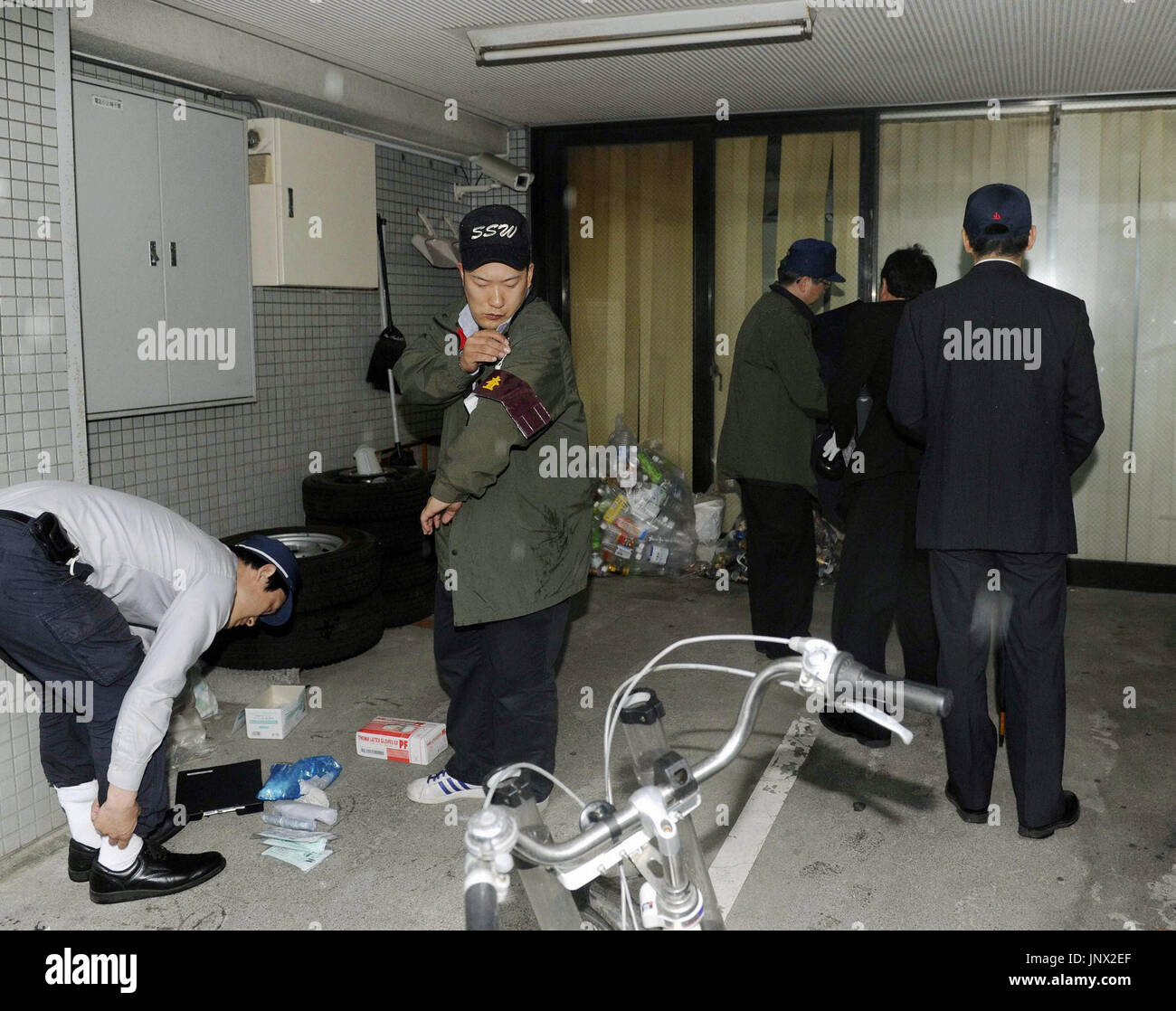 TACHIKAWA, Japan - Police officers conduct an on-site investigation at ...