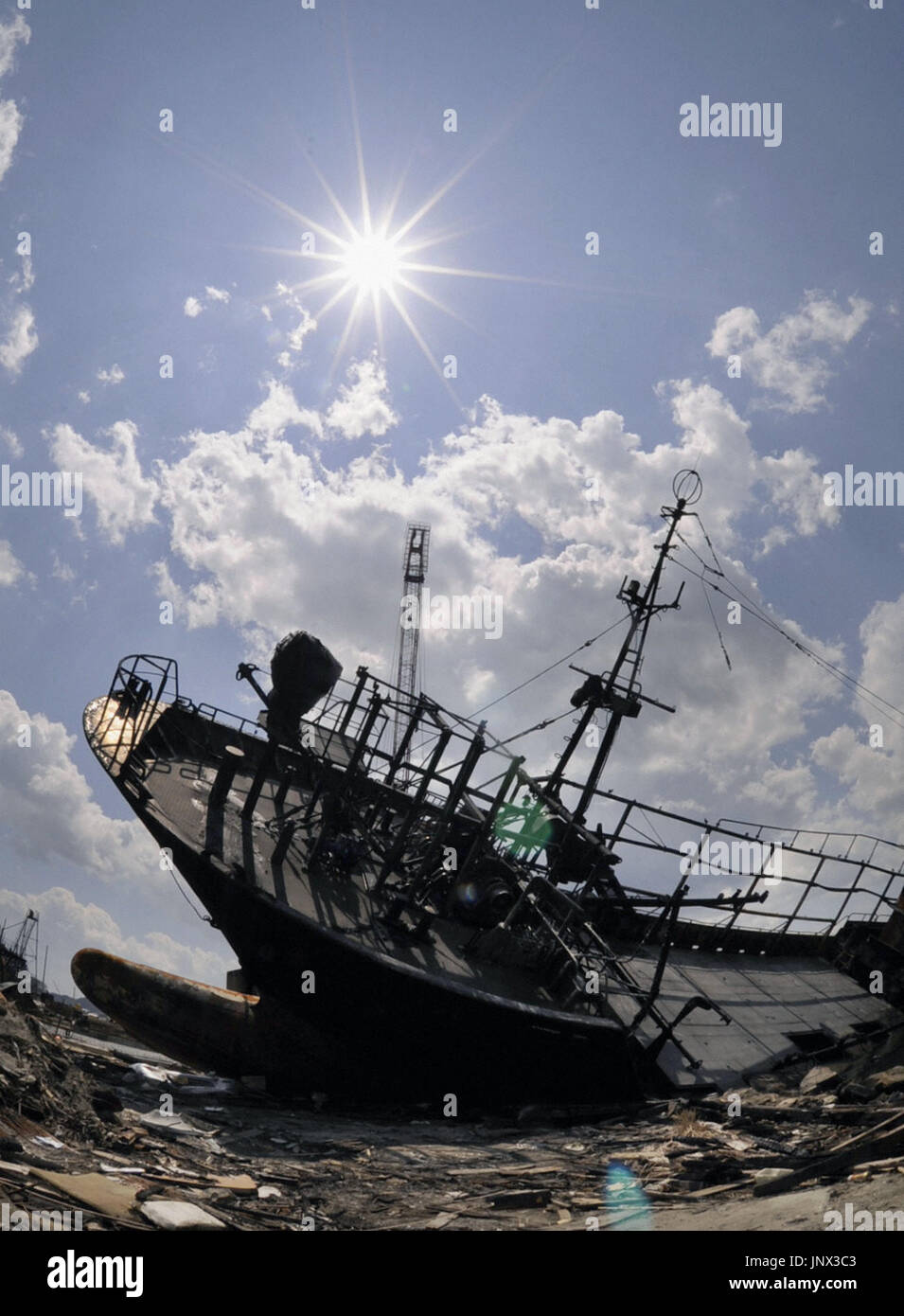 KESENNUMA, Japan - A burned ship washed ashore by the March 11 tsunami ...