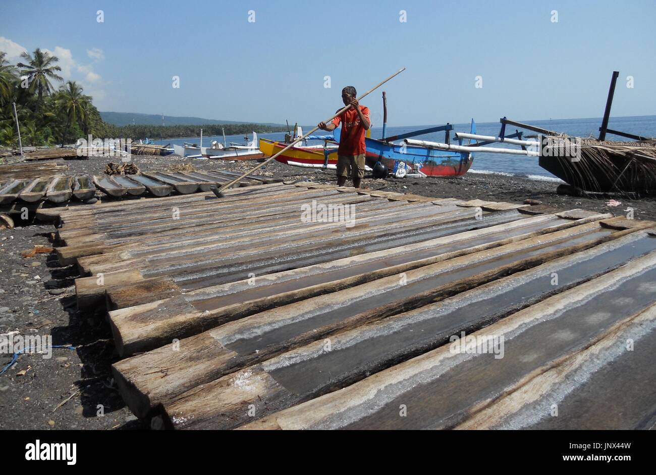 TEJAKULA, Indonesia - Ketut Sudana, 50, evaporates seawater in coconut ...
