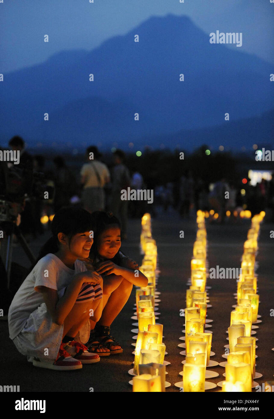 SHIMABARA, Japan - Girls watch lighted candles during an event to ...