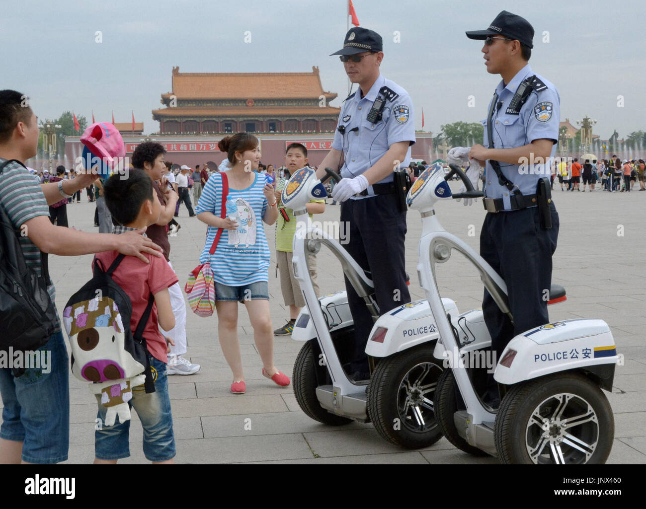 BEIJING, China - Police officers on electric two-wheeled vehicles guard ...