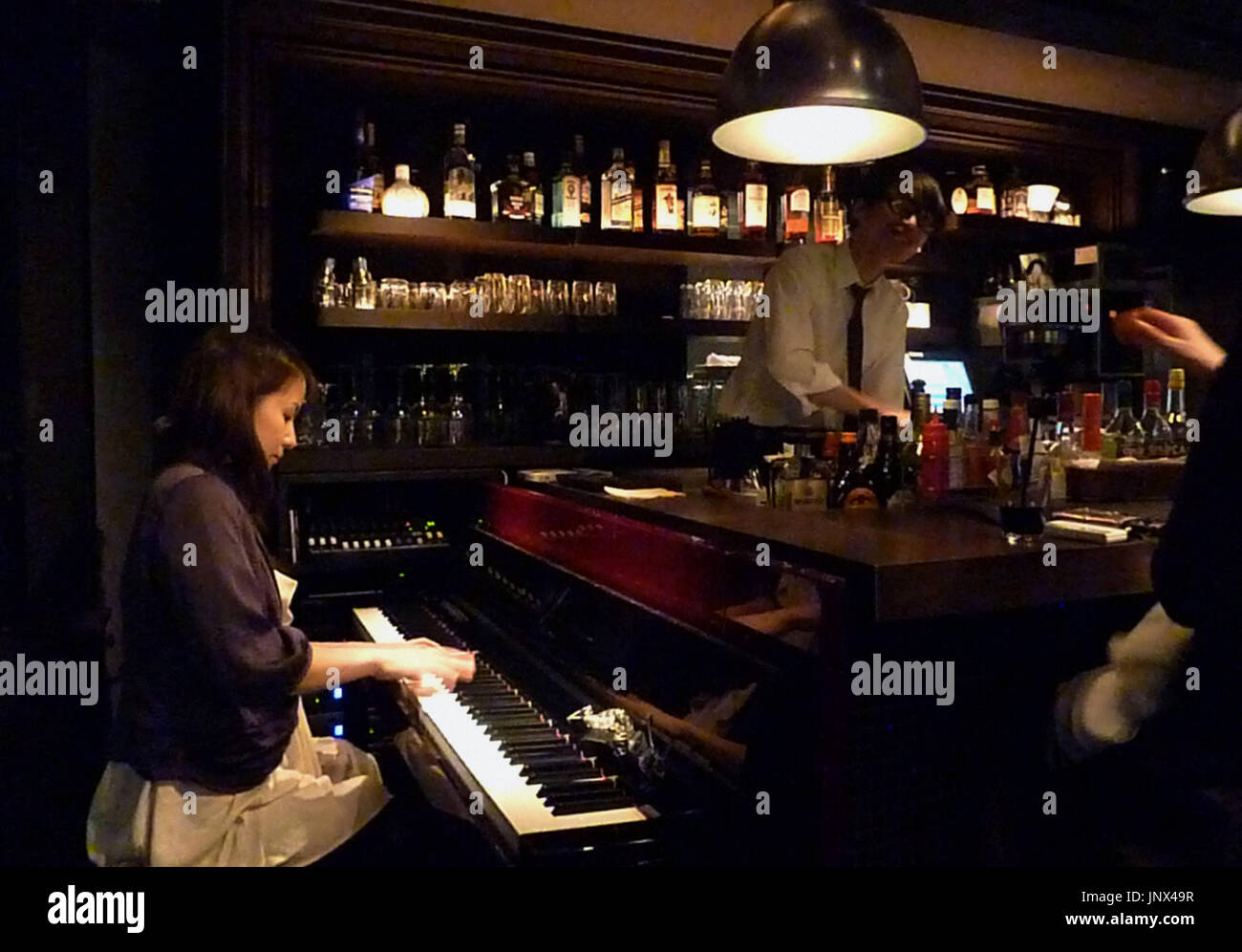 TOKYO, Japan - A woman plays piano at ''got music? Cafe & Bar'' near JR ...