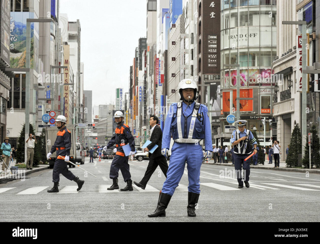 TOKYO, Japan - Police officers control traffic in the Ginza shopping ...