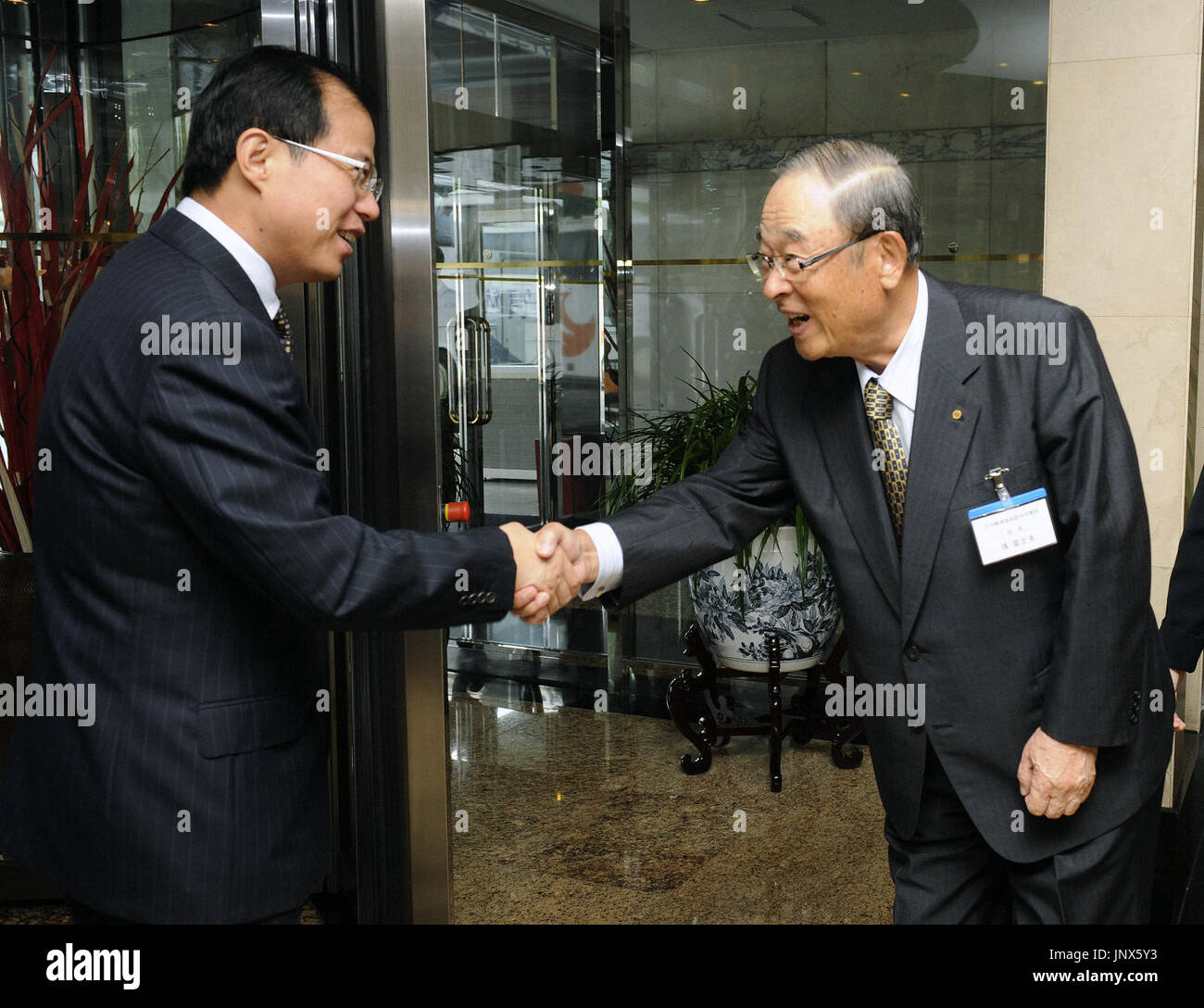 BEIJING, China - Toyota Motor Corp. Chairman Fujio Cho (R), who led a ...