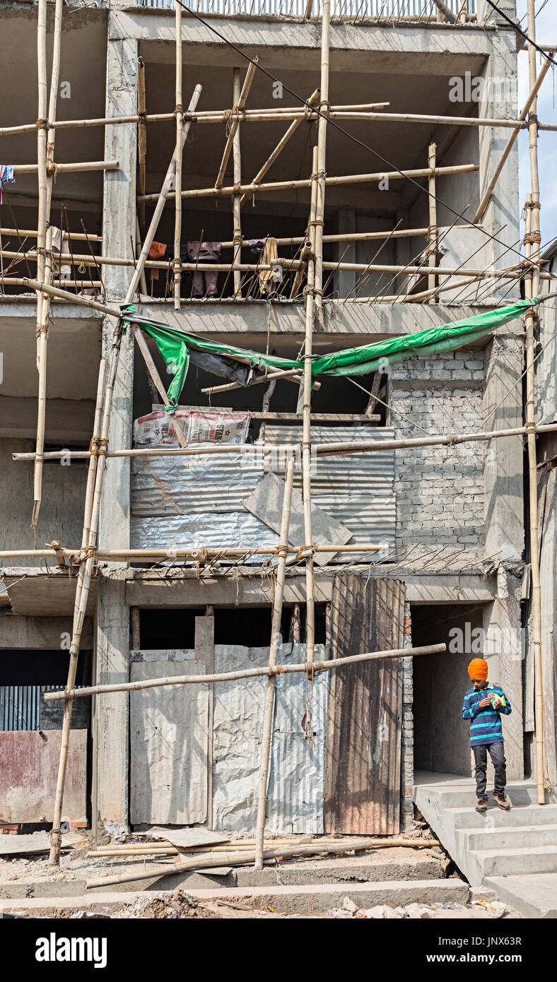Man walking out of building with bamboo scaffolding, Shillong ...