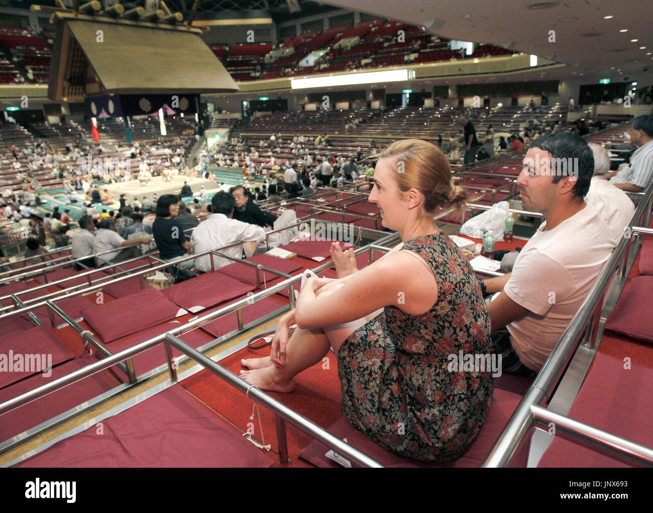TOKYO, Japan - Australian travelers (front) watch sumo bouts in ...