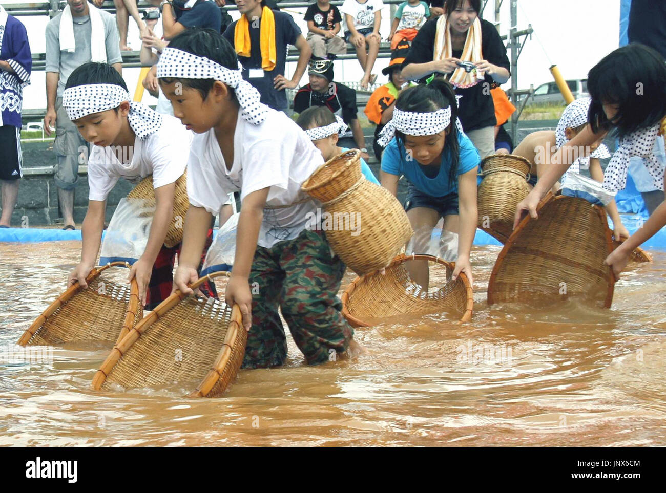 MATSUE, Japan - Children scoop loaches during a loach festival in ...