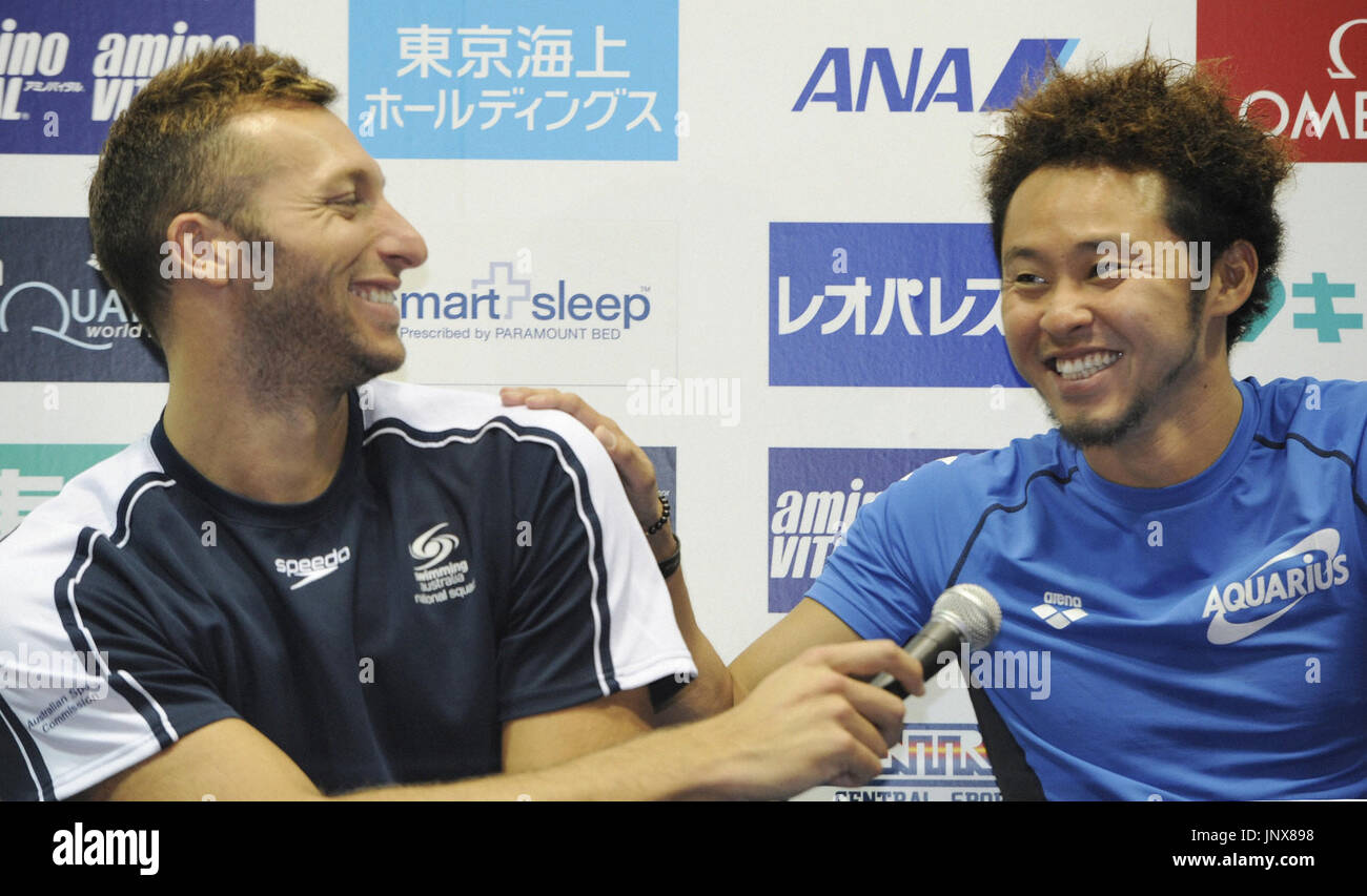 TOKYO, Japan - Ian Thorpe (L) of Australia turns a microphone to Japan ...