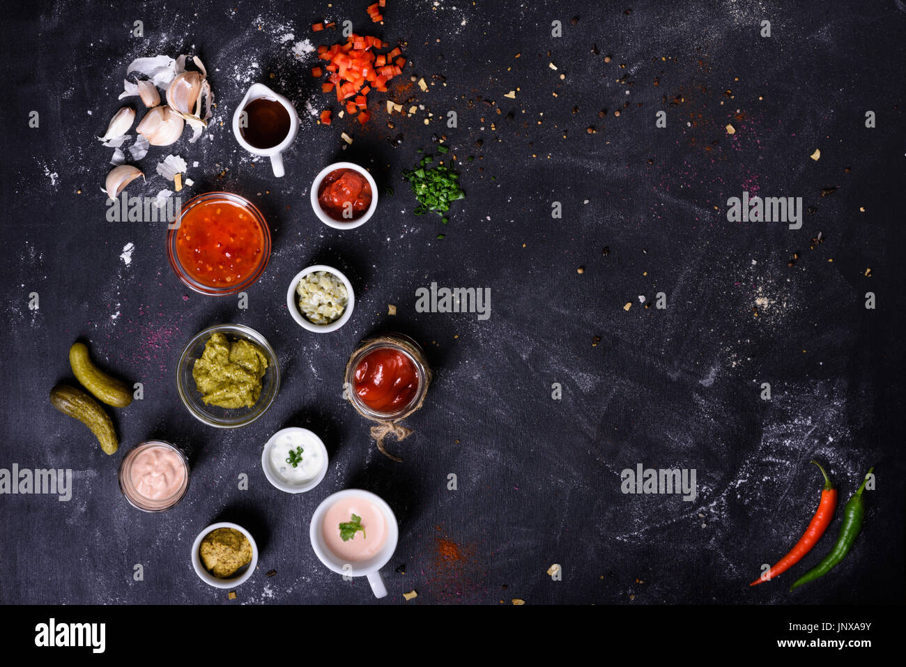Sauces, appetizers and cooking ingredients, food background on messy ...