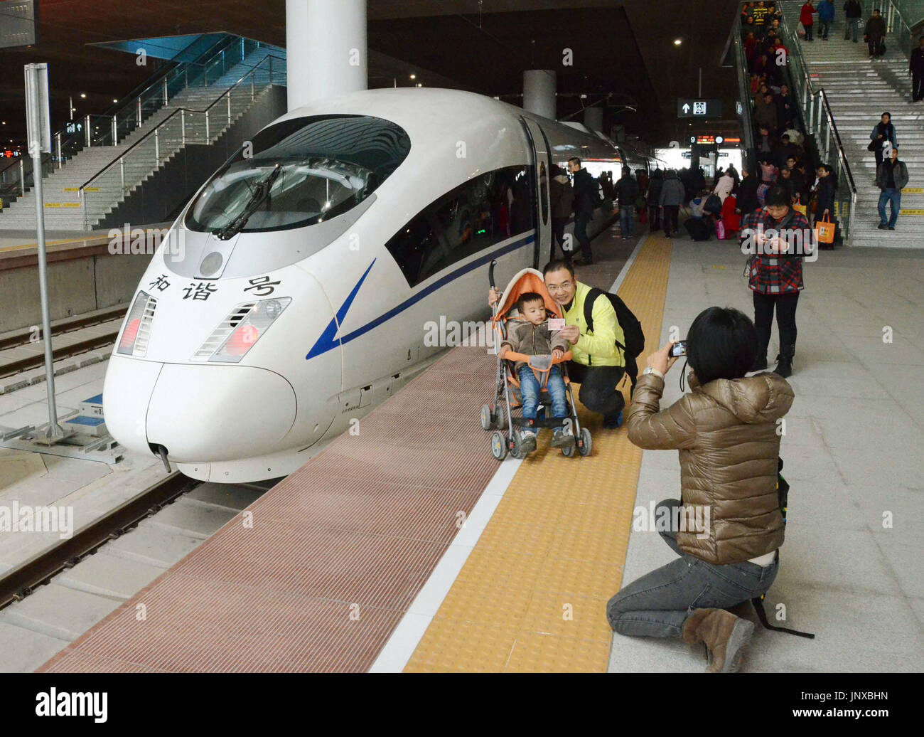 SEHNZHEN, China - People take pictures in front of a bullet train at a ...