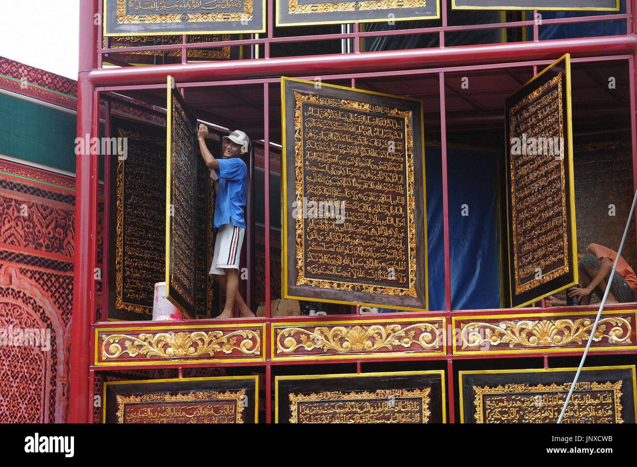 JAKARTA, Indonesia - A man cleans a 15-meter tower with wooden panels ...