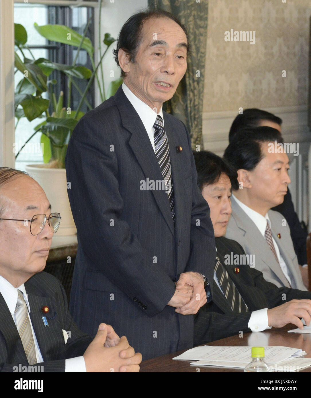 TOKYO, Japan - Azuma Koshiishi (standing), secretary general of the ...
