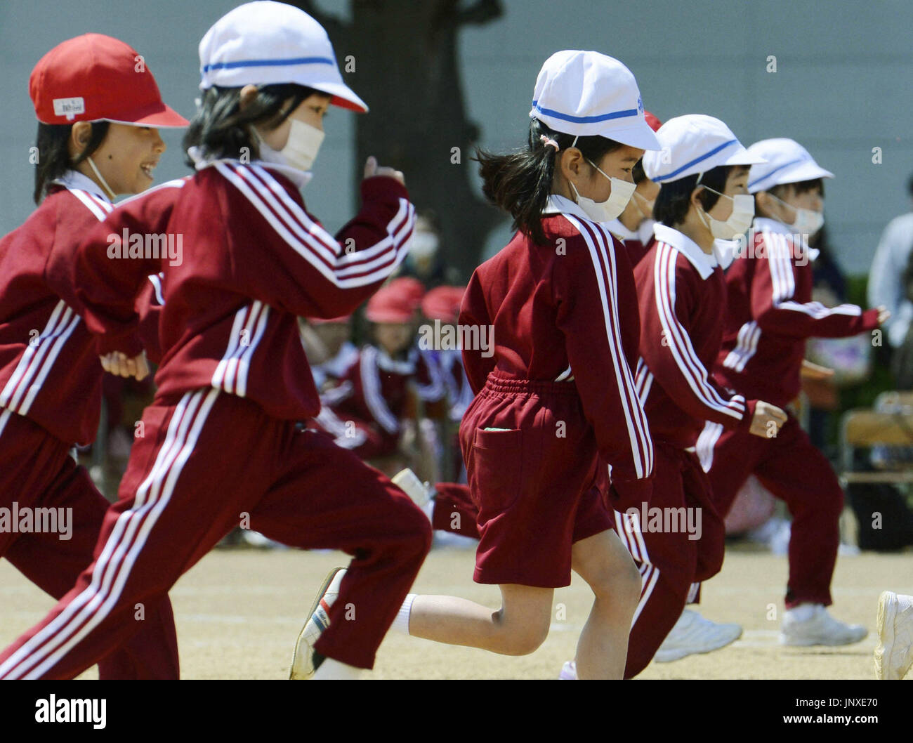 FUKUSHIMA, Japan - Pupils, most of them wearing surgical masks, at ...